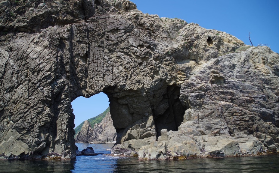 Caves and odd rock formations on a little island in the Sea of Japan ...